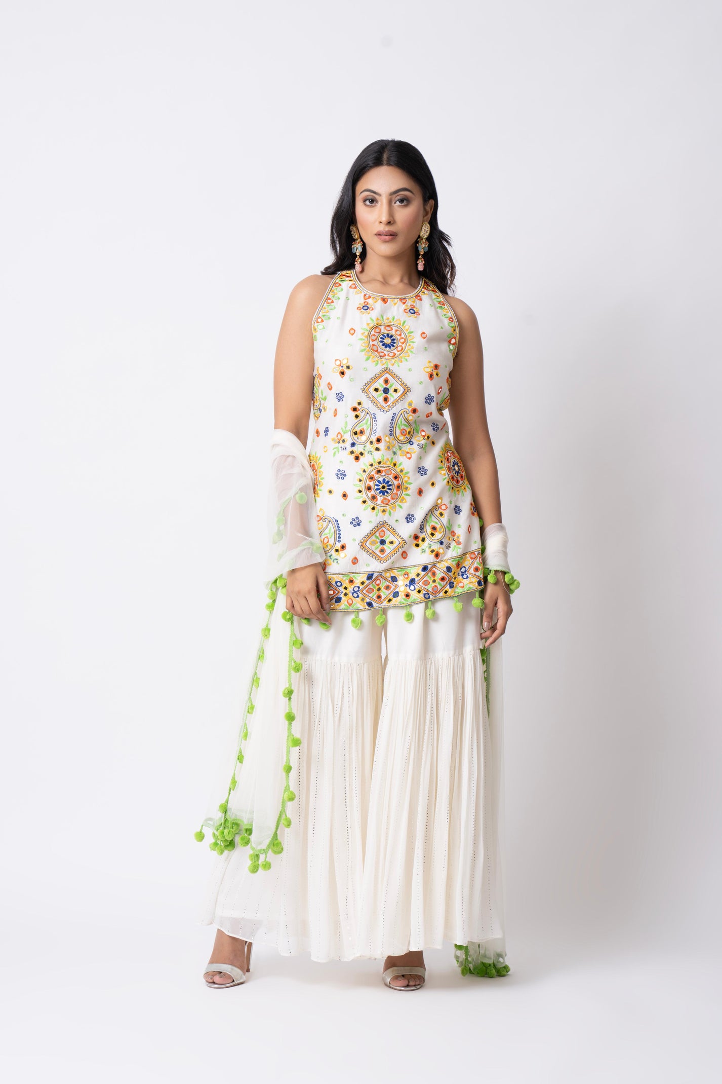 White Gharara set with mirrorwork embellisment on the kurta and plain ...