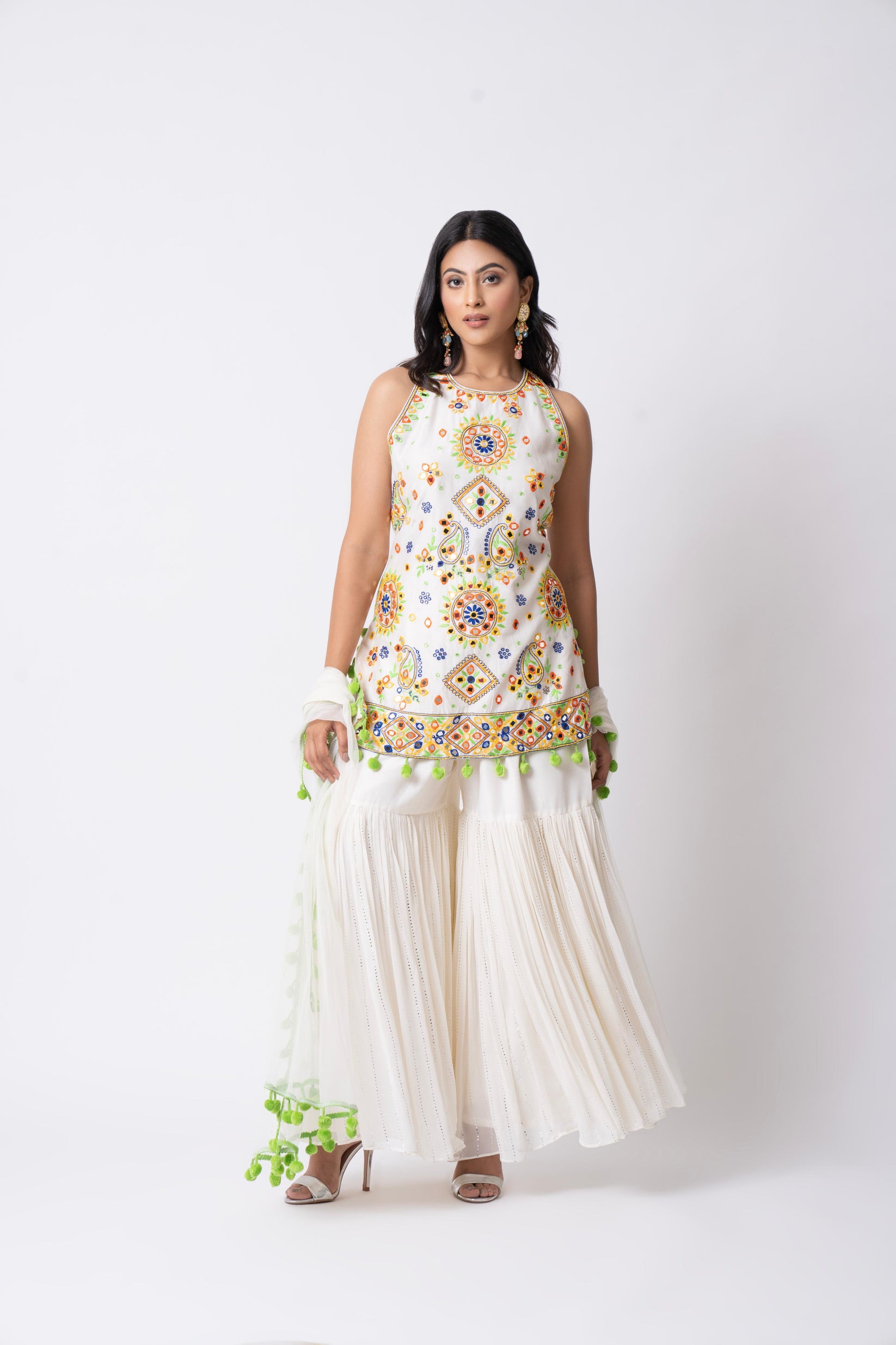 White Gharara set with mirrorwork embellisment on the kurta and plain ...